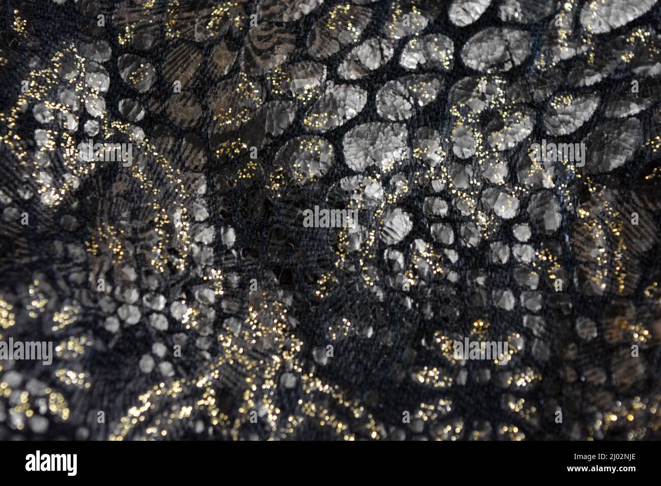 Black dark fabric background with gilding, gold flower patterns with ...