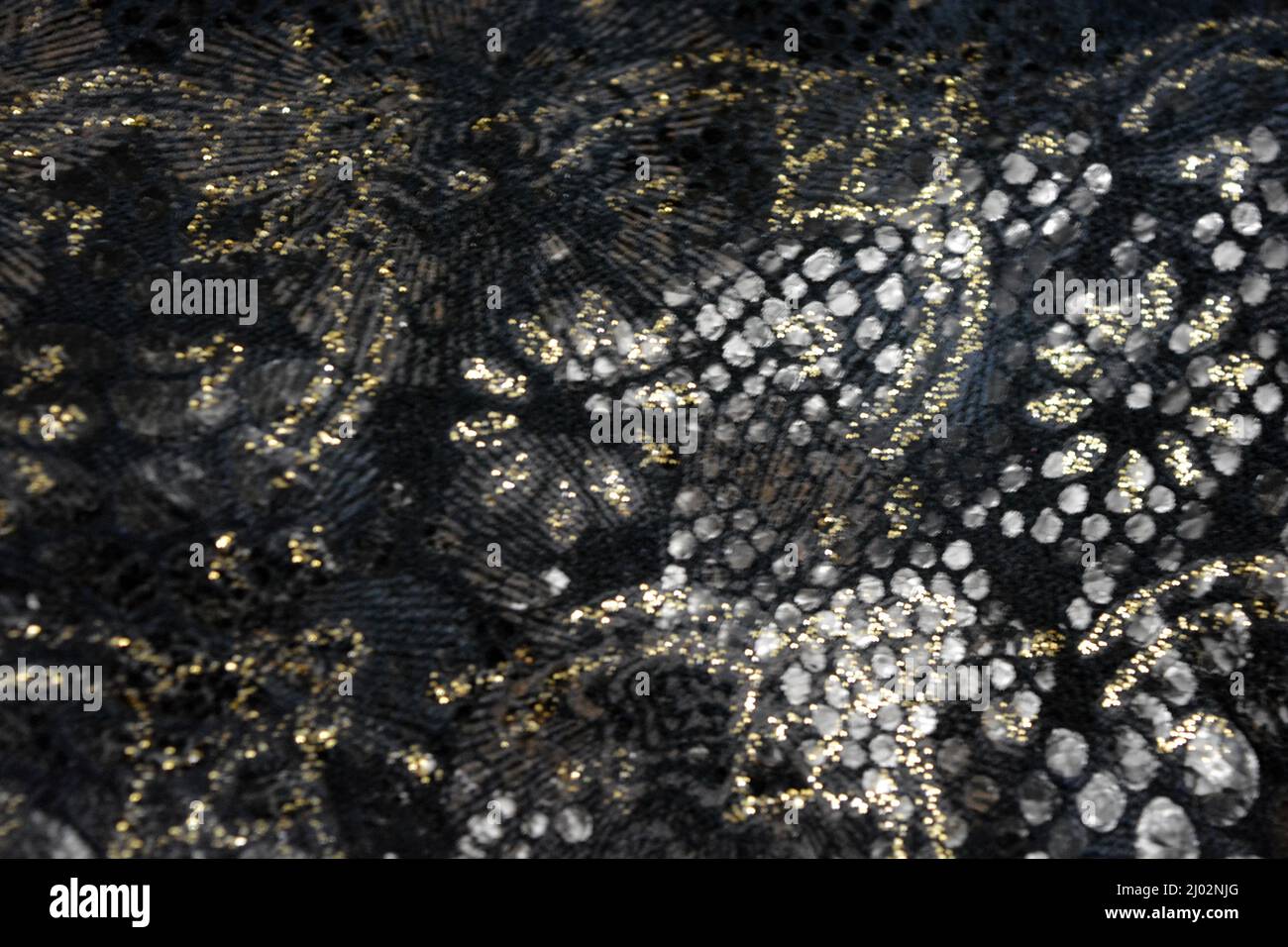 Black dark fabric background with gilding, gold flower patterns with ...
