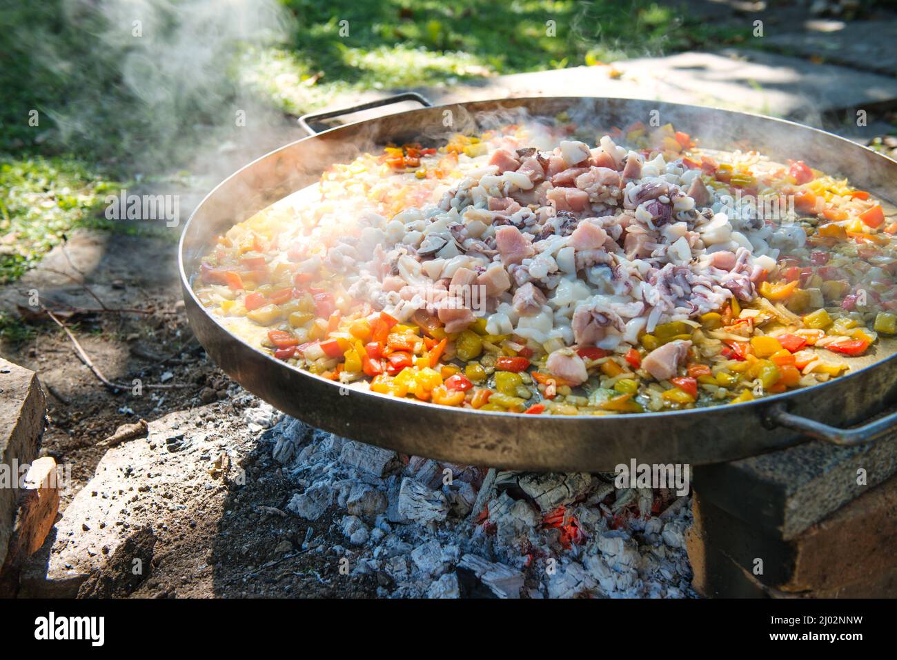Wood embers for the preparation of paella in the classic large pan ...