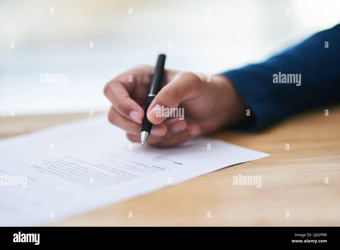 Sign on the dotted line. Shot of a person signing paperwork Stock Photo ...