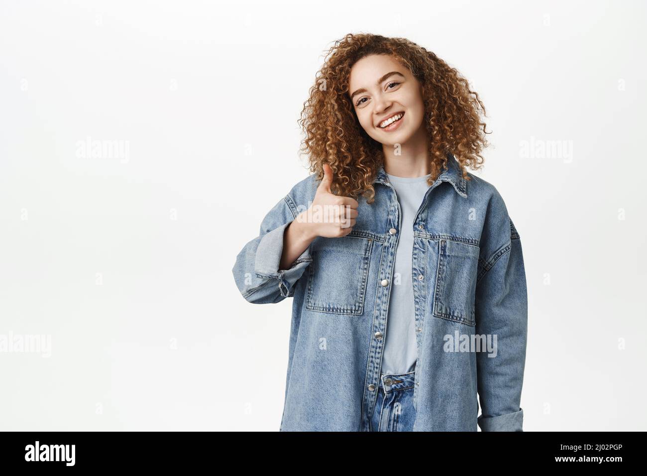 Happy beautiful girl showing thumbs up, like and approve, recommending ...