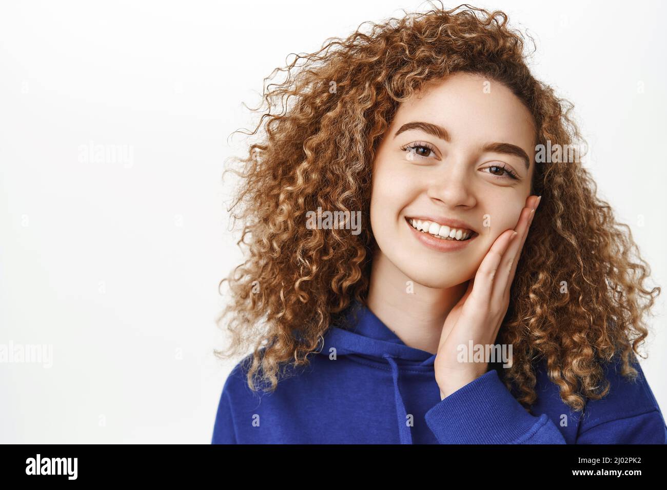 Beauty and wellbeing. Close up portrait of beautiful curly girl with ...
