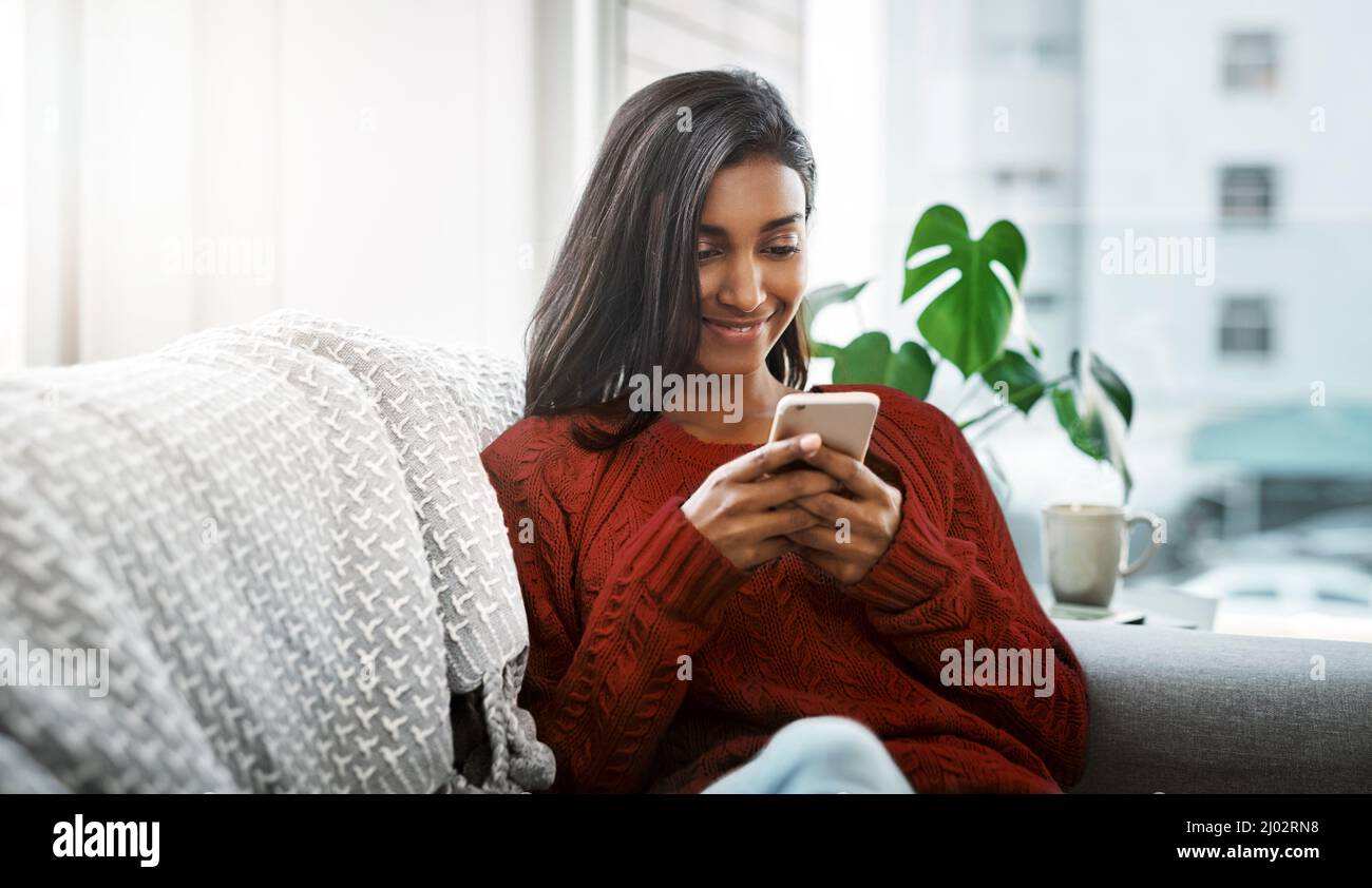 Chilling and chatting in the living room. Cropped shot of a beautiful ...