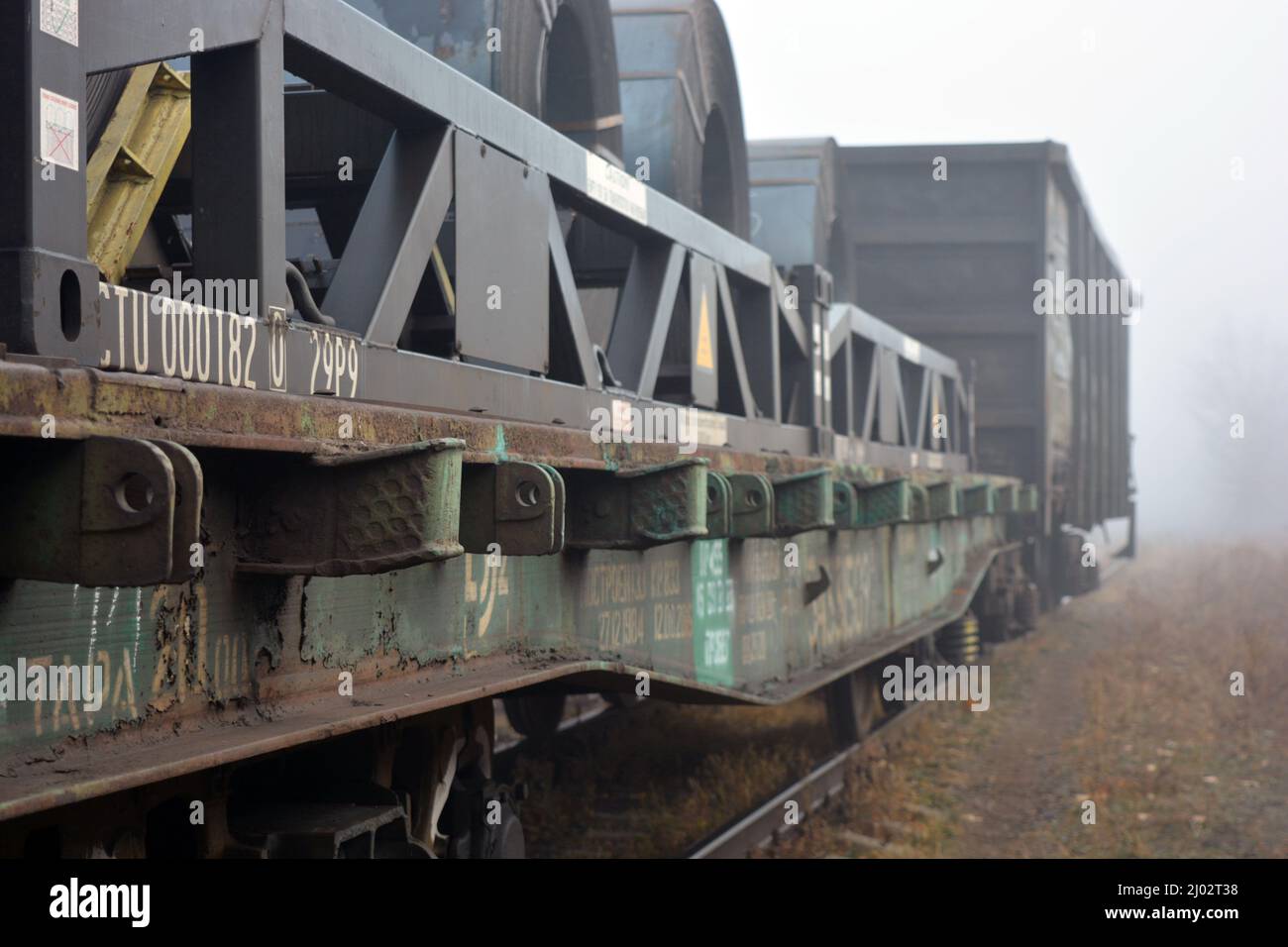 Sand paths along the railway, metal rails with a heavy metal engine and ...