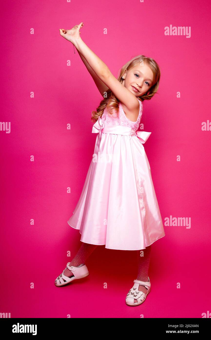 Pretty young kid girl in pink dress.Isolated studio shot Stock Photo ...
