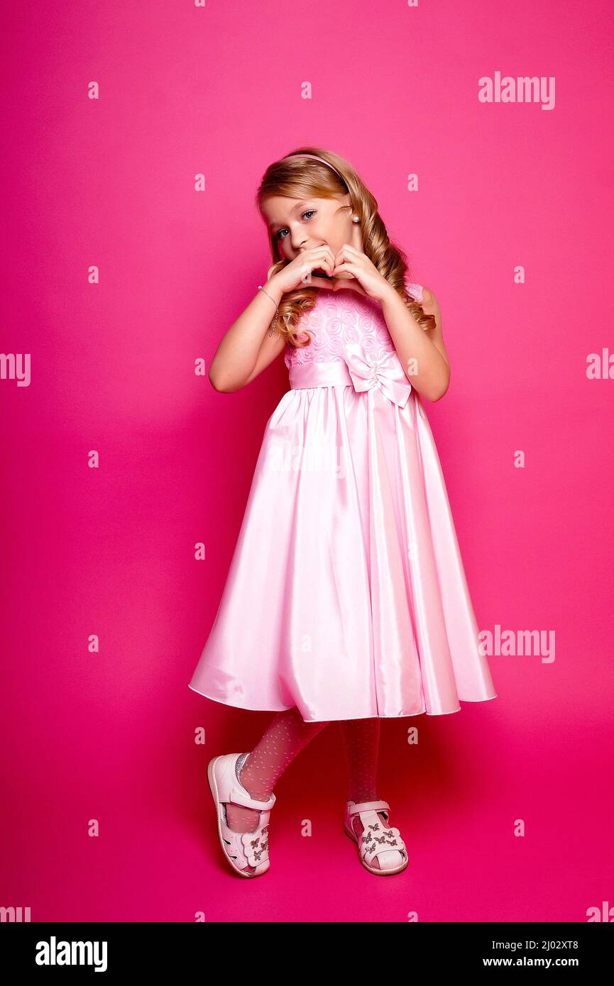 Pretty young kid girl in pink dress.Isolated studio shot Stock Photo ...