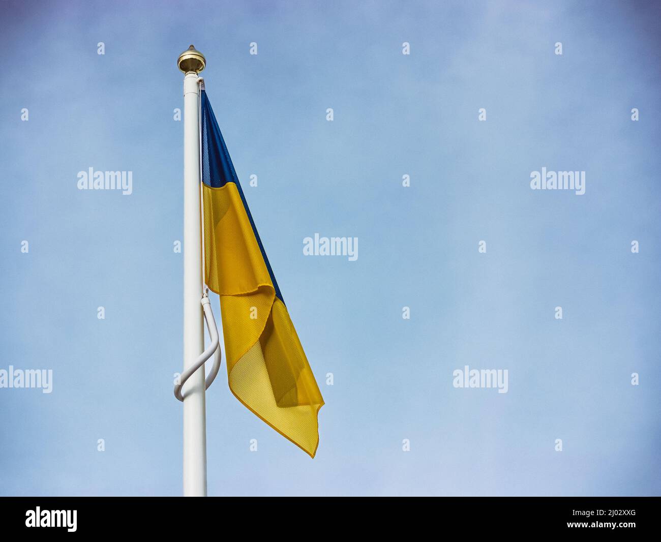Ukraine flag against the sky. White flagpole with the flag of ukraine ...