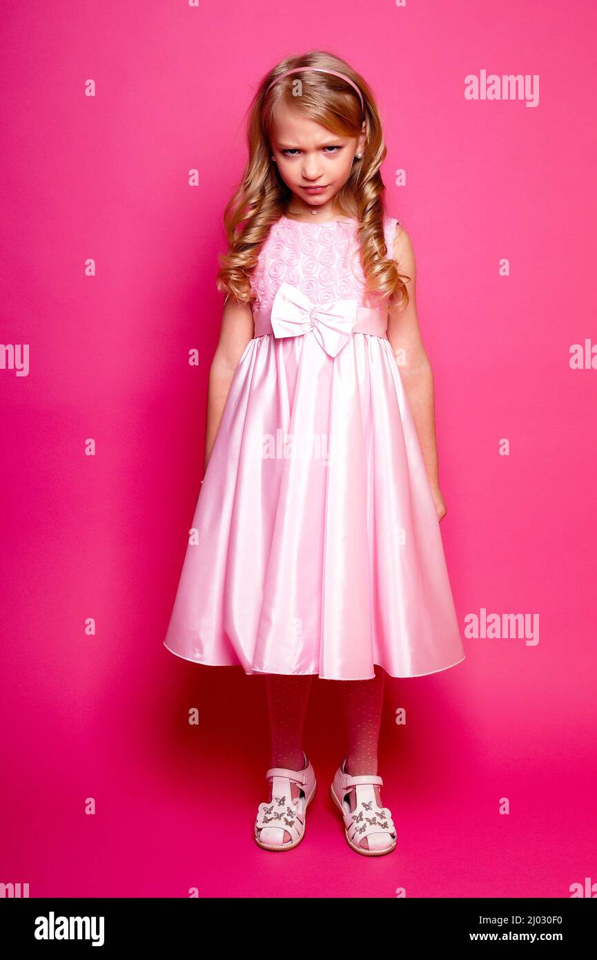 Pretty young kid girl in pink dress.Isolated studio shot Stock Photo ...