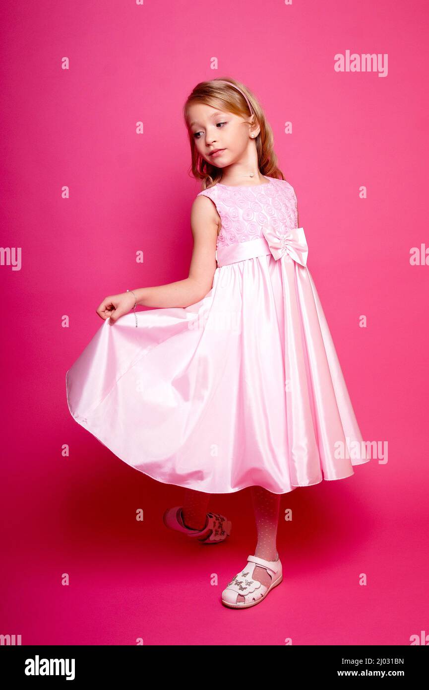 Pretty young kid girl in pink dress.Isolated studio shot Stock Photo ...