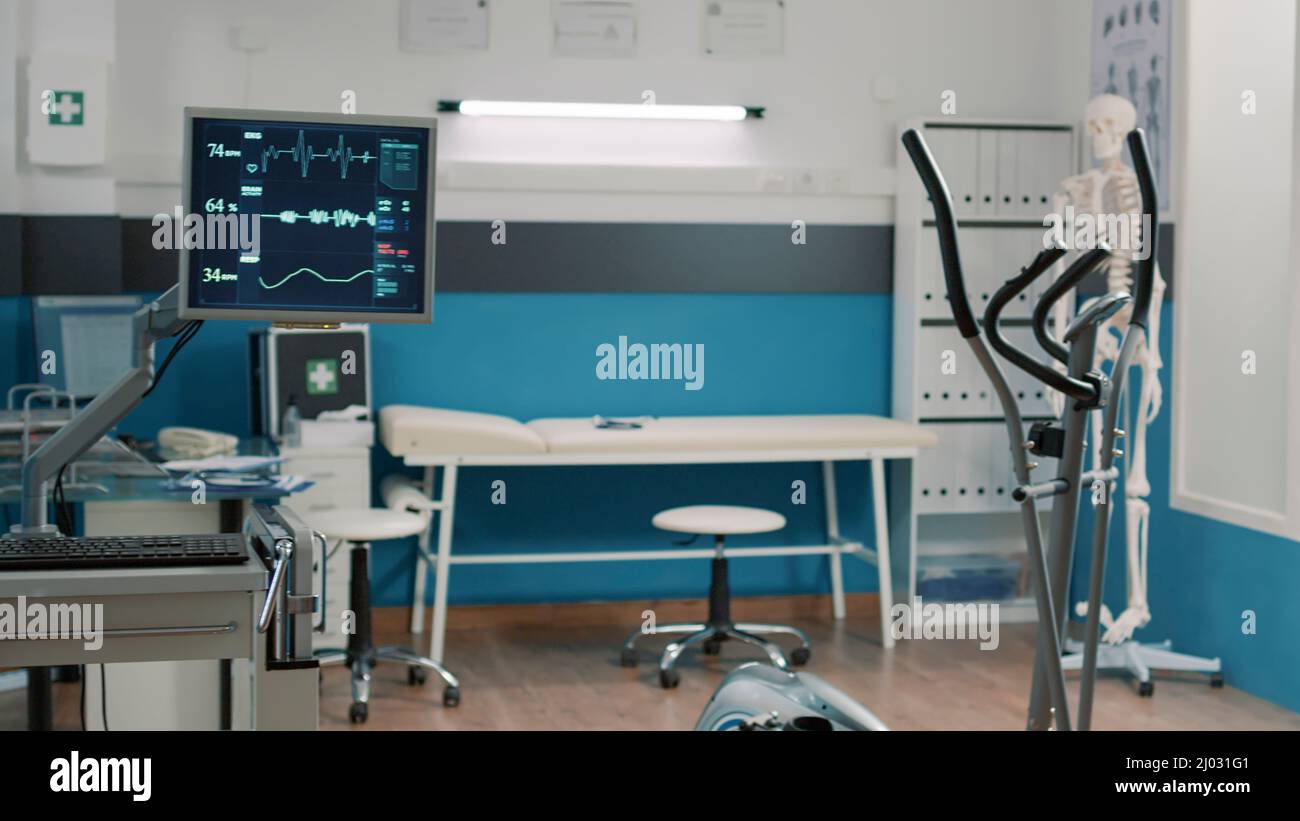Empty cabinet with heart rate monitor and stationary bicycle to do ...