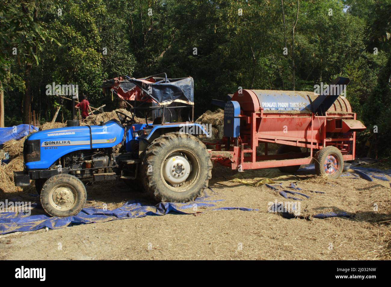 Tractor mounted threshing machine Stock Photo - Alamy