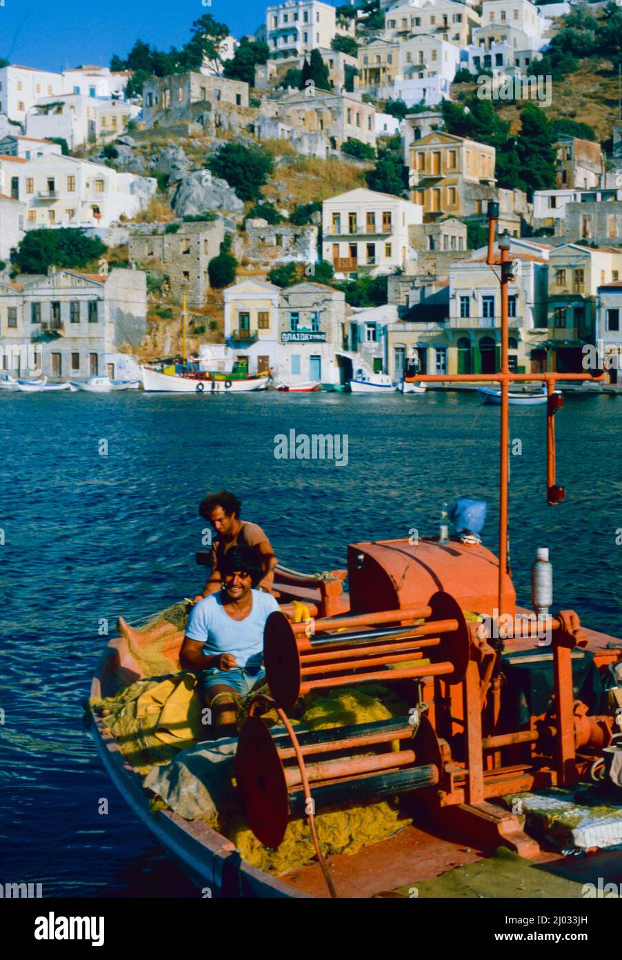 Fishing in Symi Harbour, Crete Stock Photo - Alamy