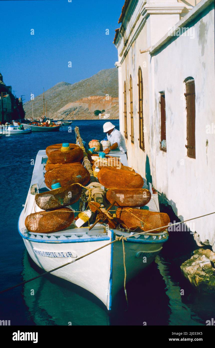 Fishing in Symi Harbour, Crete Stock Photo - Alamy