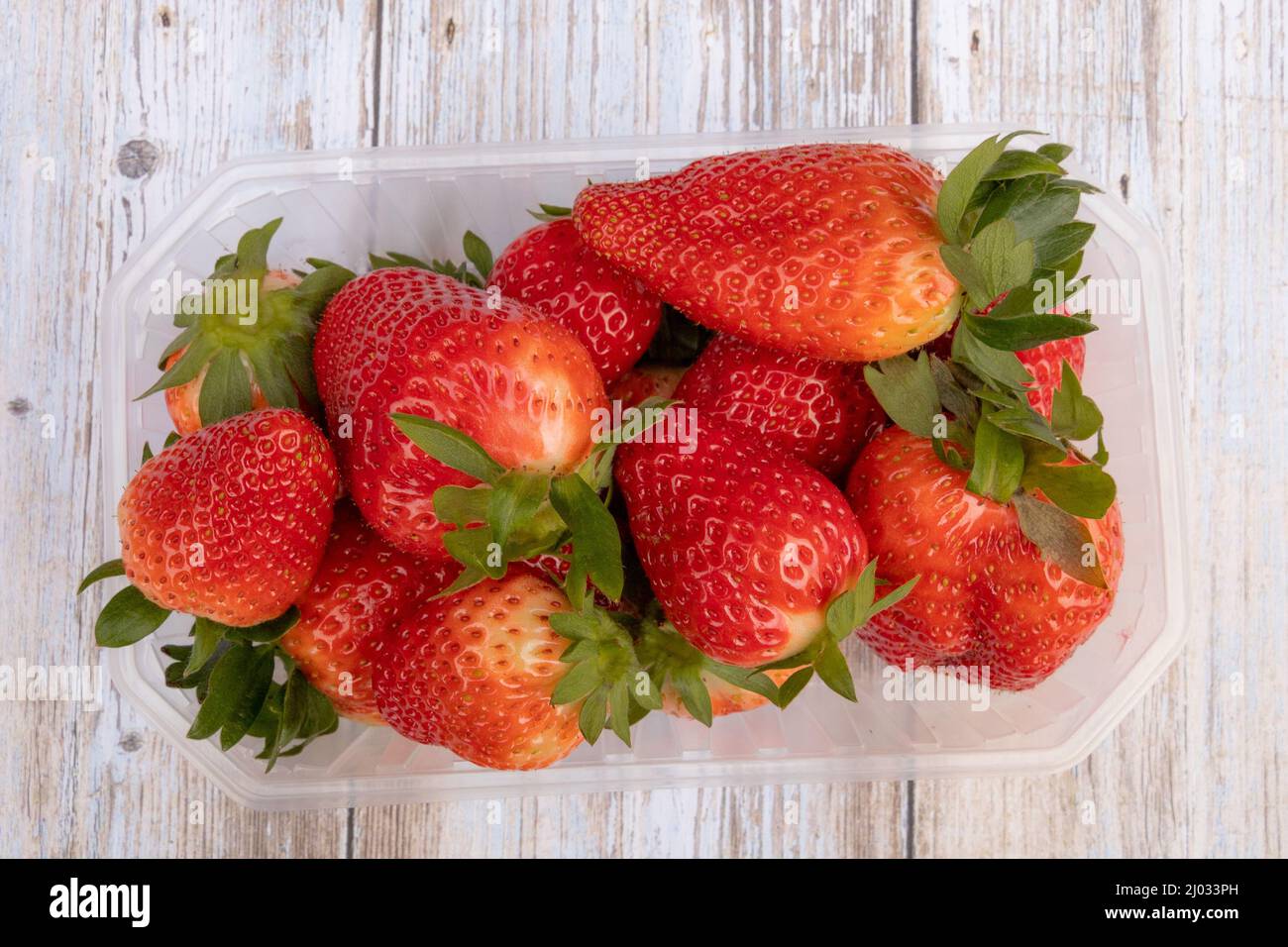 strawberry in a punnet on a white background Stock Photo - Alamy