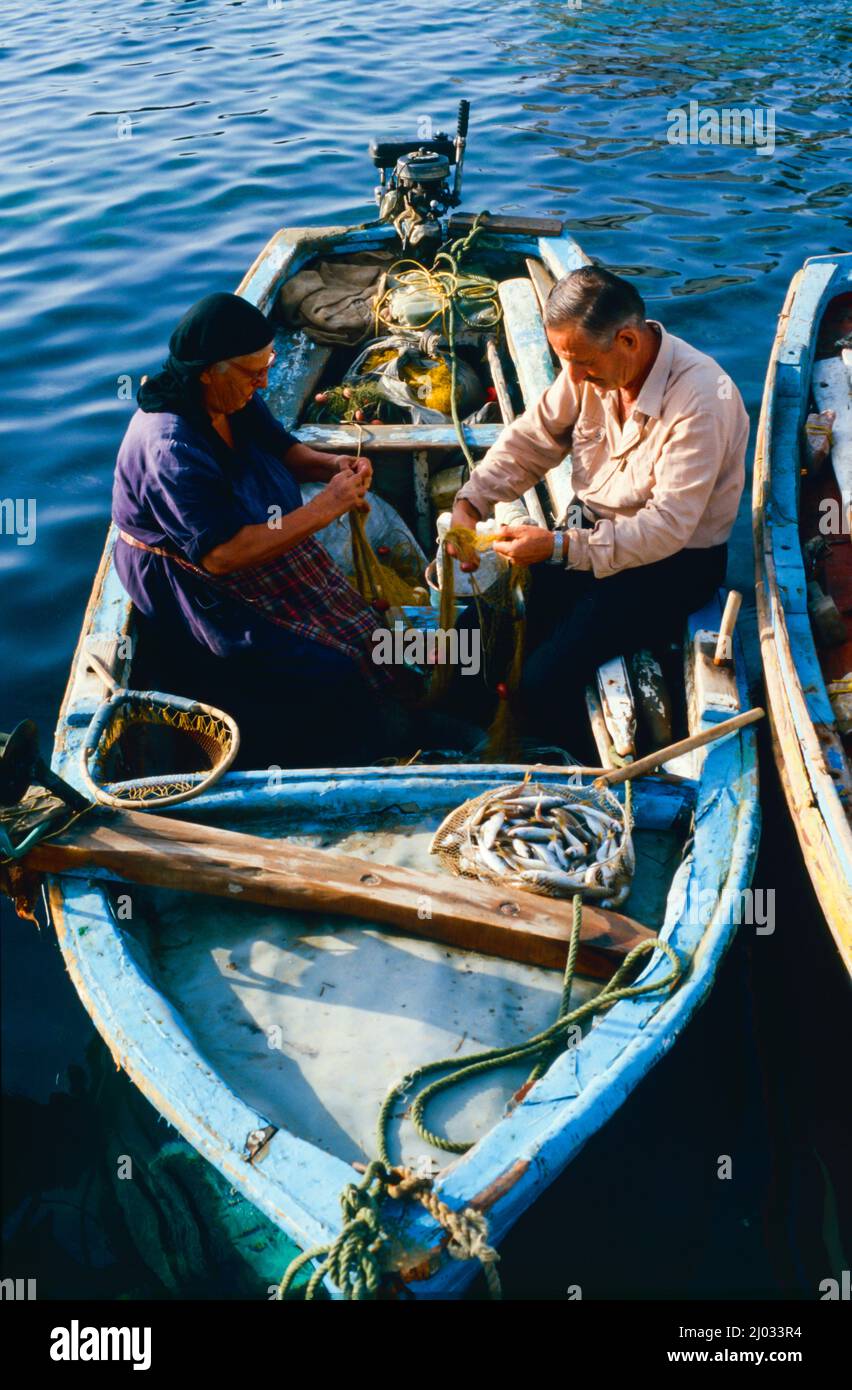 Fishing in Symi Harbour, Crete Stock Photo - Alamy
