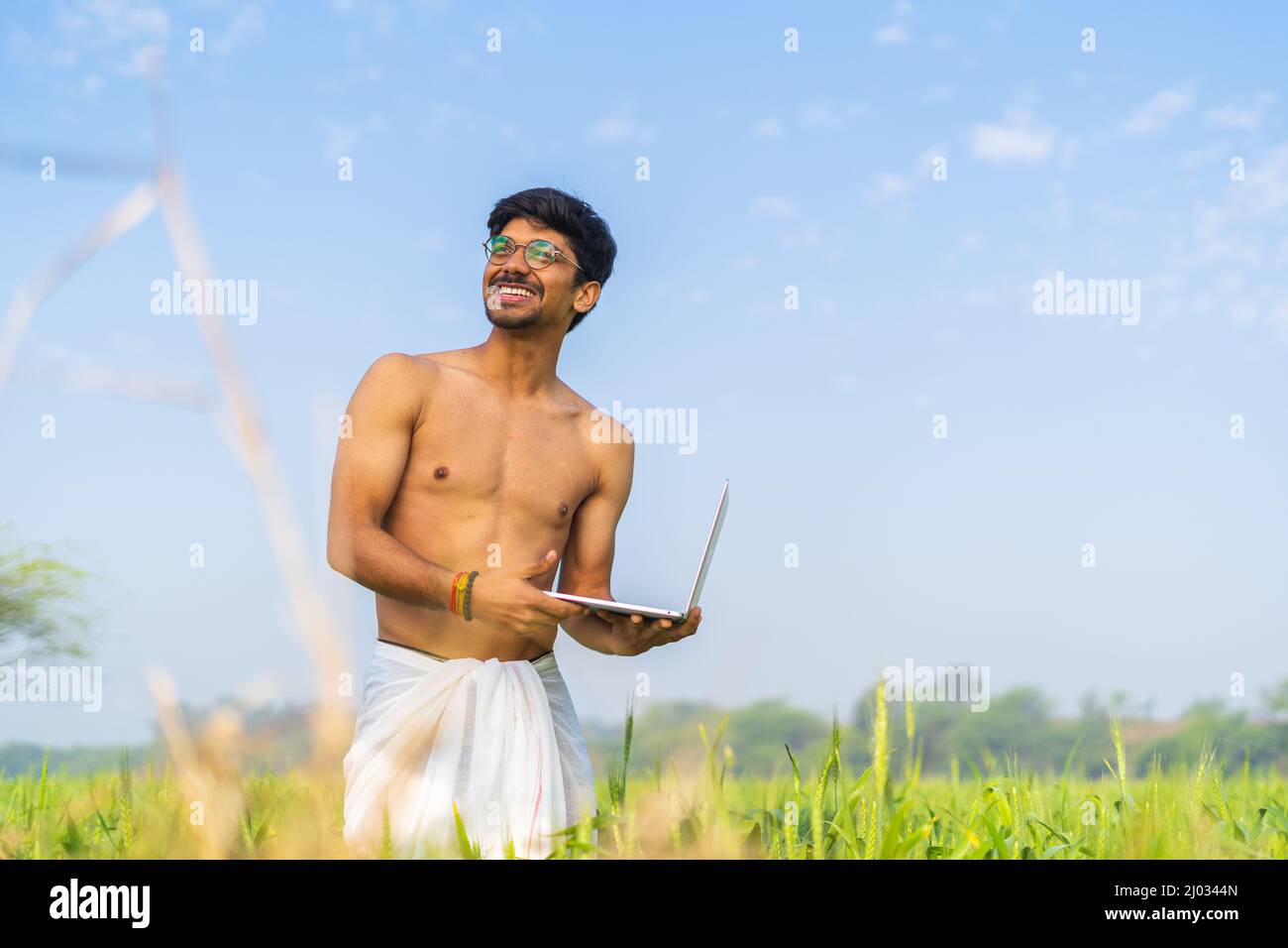Young Indian male wearing dhoti and working in the fields Stock Photo ...