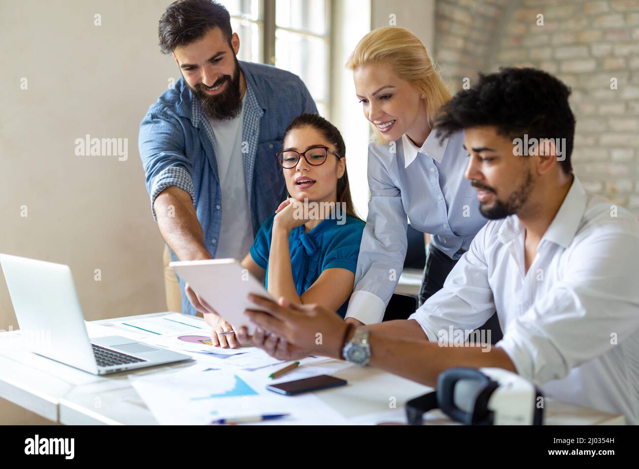 Working on new project together. Group of happy business people ...