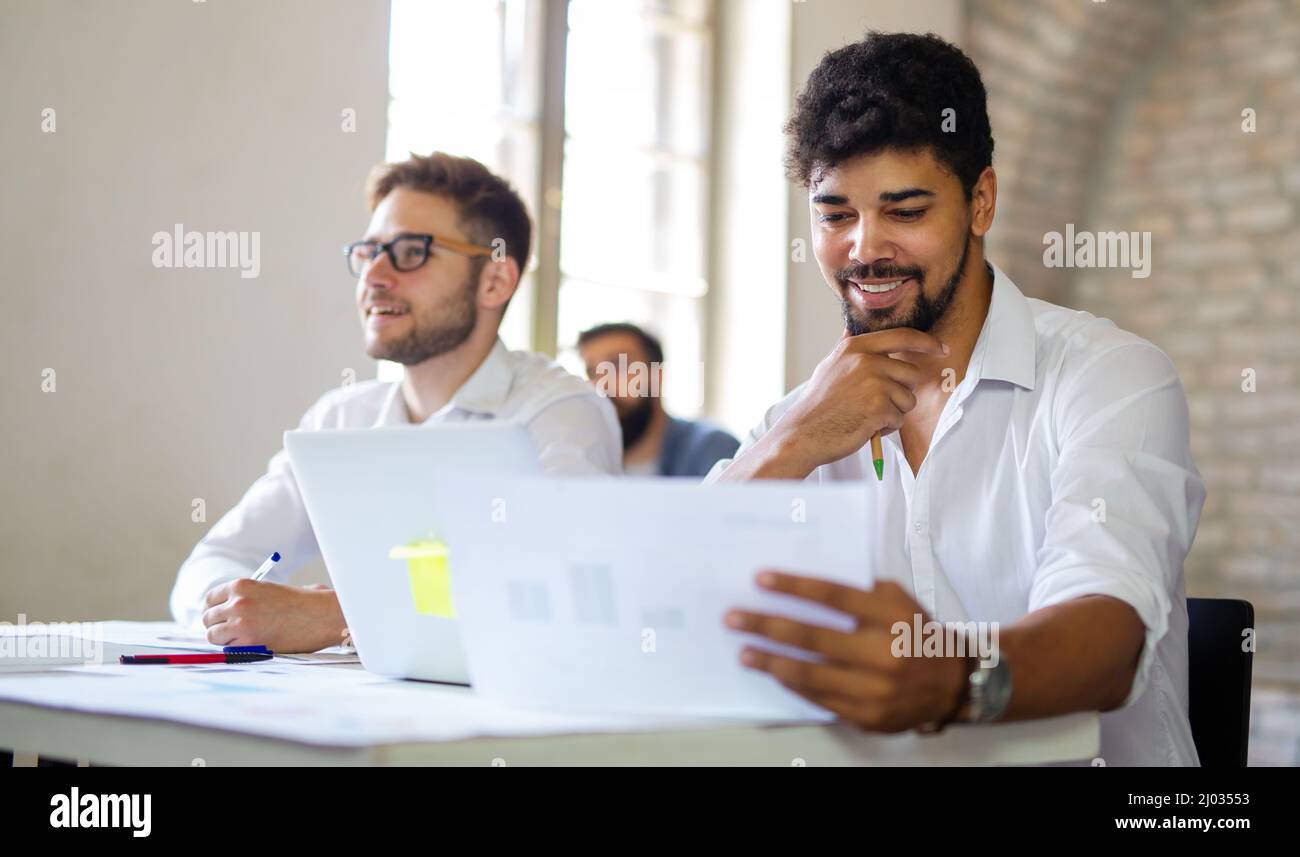 Group of happy multiethnic business people cooperating, working on ...
