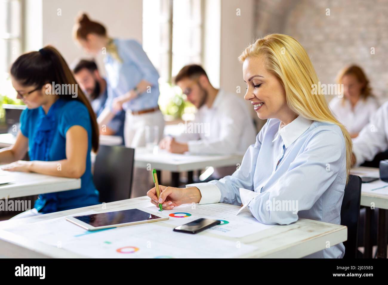 Group of multiethnic business people cooperating during business ...