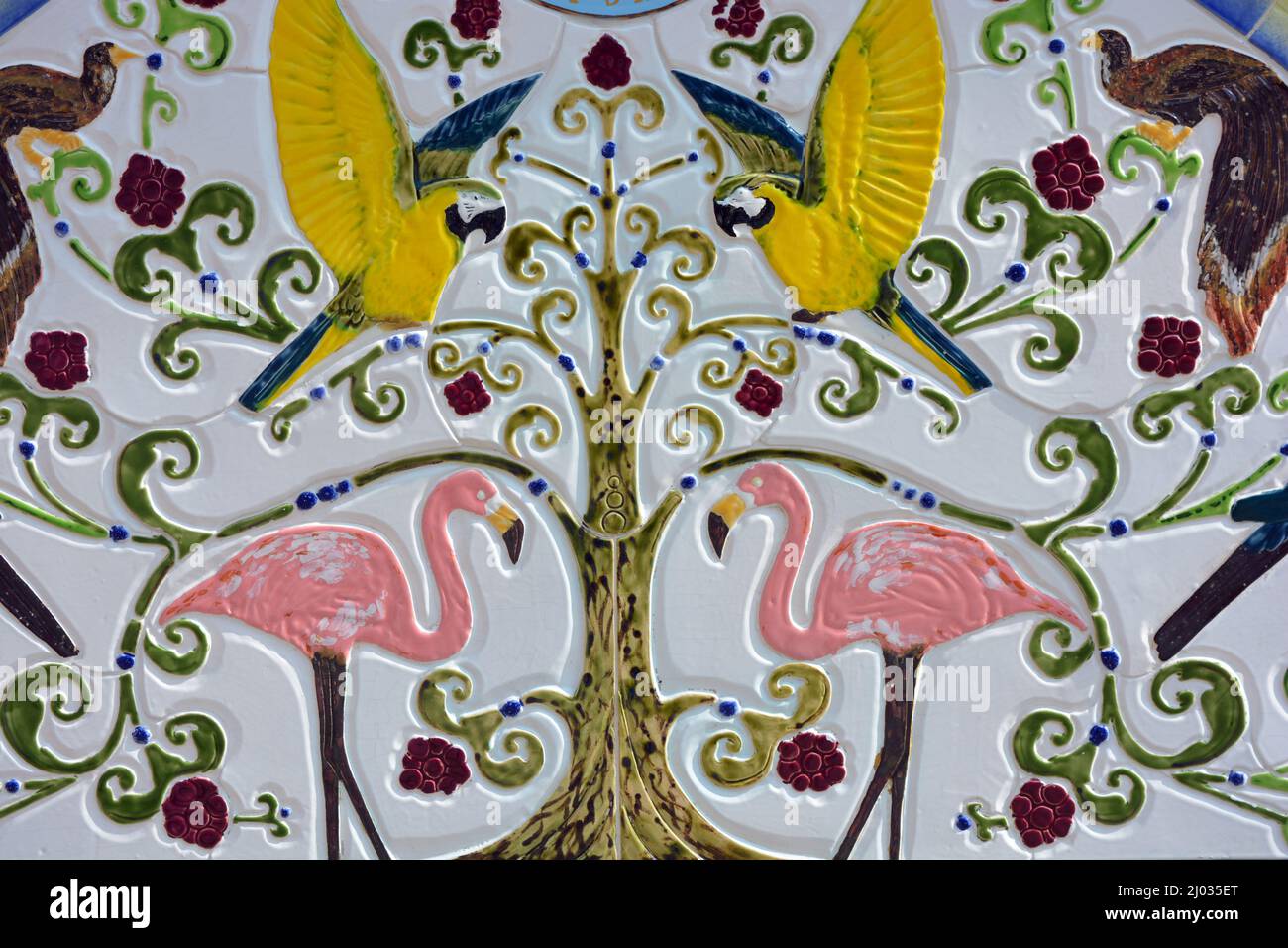 Beautiful bright peacock pattern made of colored porcelain and faience ...