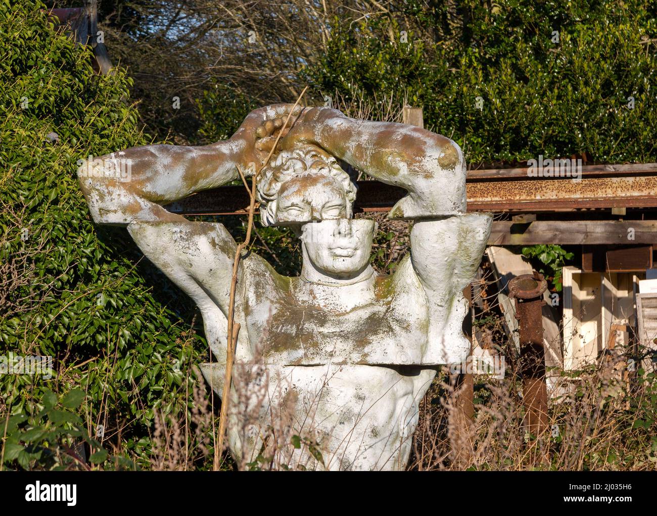 Large classical sculpture of male figure with misaligned sections ...