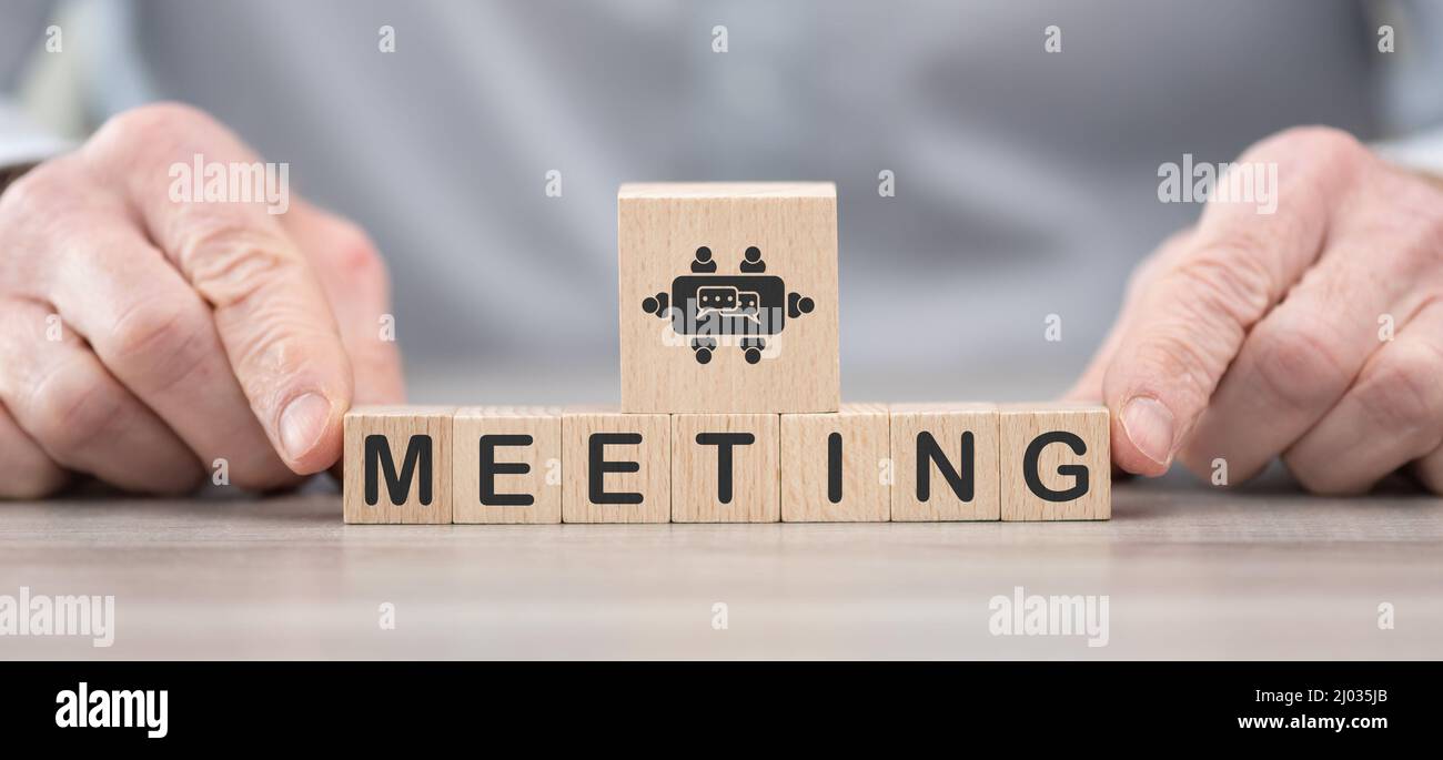 Wooden blocks with symbol of meeting concept Stock Photo - Alamy