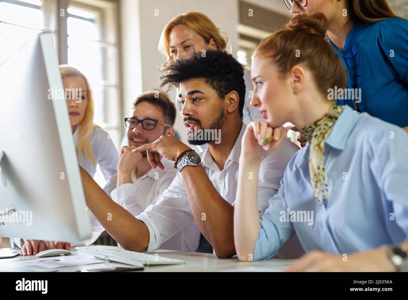 Group of multiethnic business people cooperating during business ...