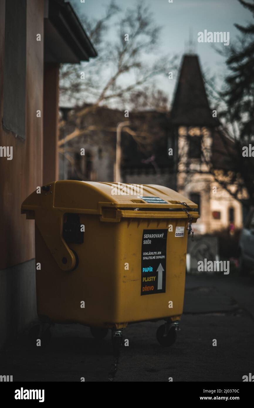Yellow trash can for recycle materials with blurred background on the ...