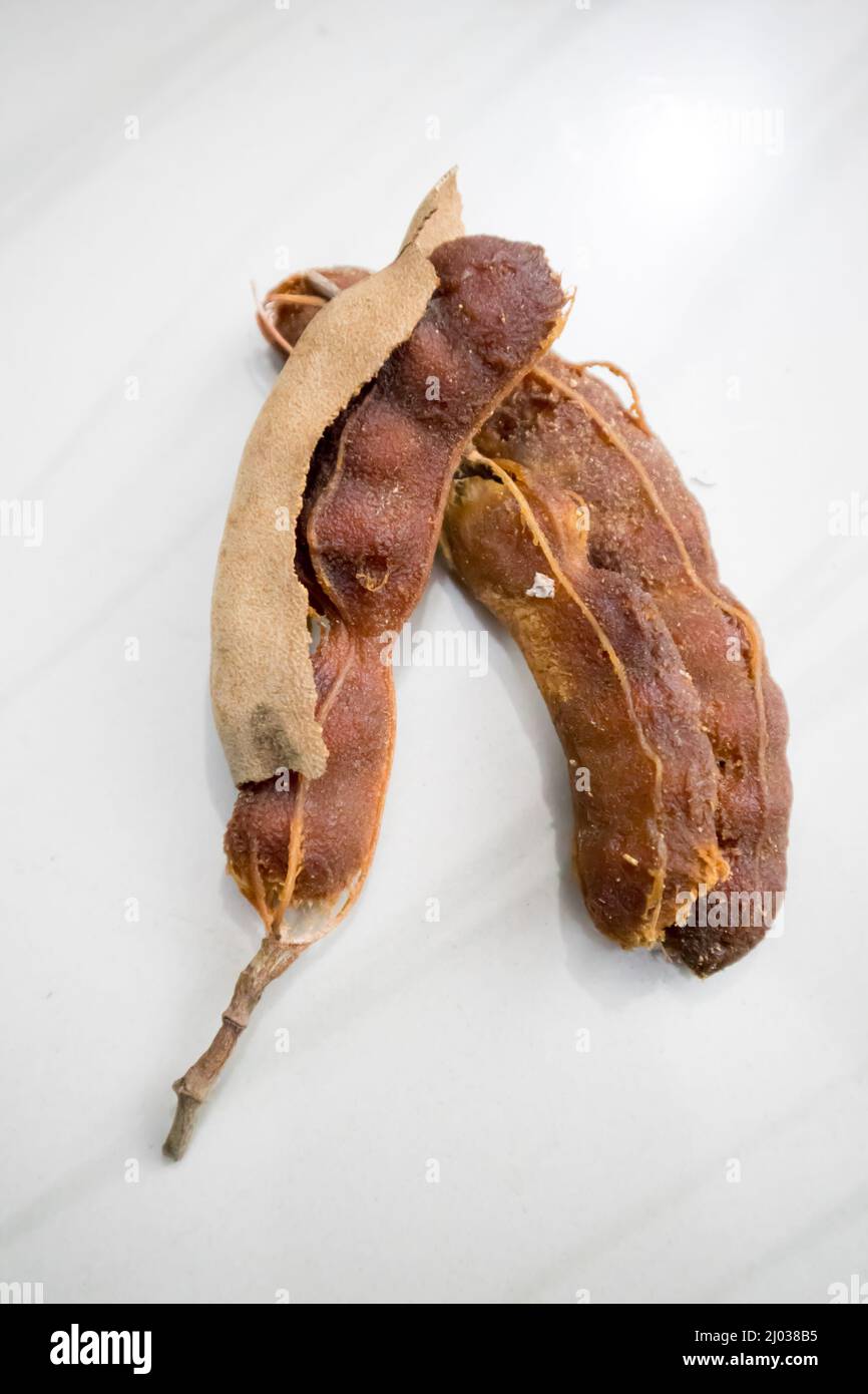 Some peeled tamarind with the shell in a white background Stock Photo ...