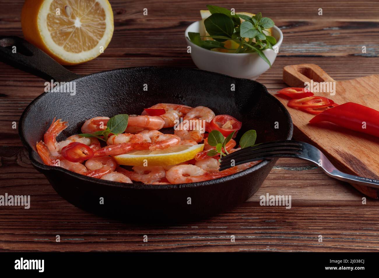 Shrimp pinchos tapas from Spain in pan, red pepper, lemon on wooden ...