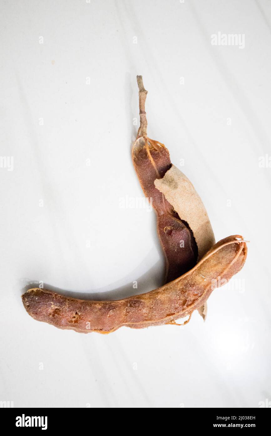 Two peeled tamarind with the shell in a white background Stock Photo ...