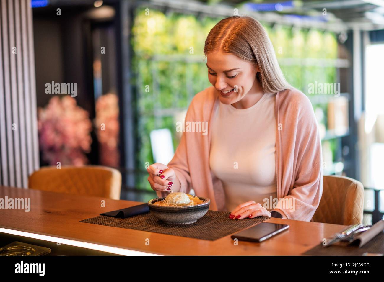 Woman eating dessert smiling hi-res stock photography and images - Alamy