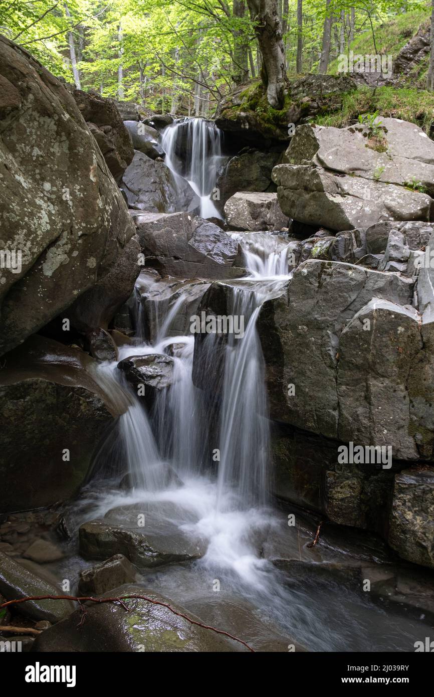 Person in between rocks hi-res stock photography and images - Alamy