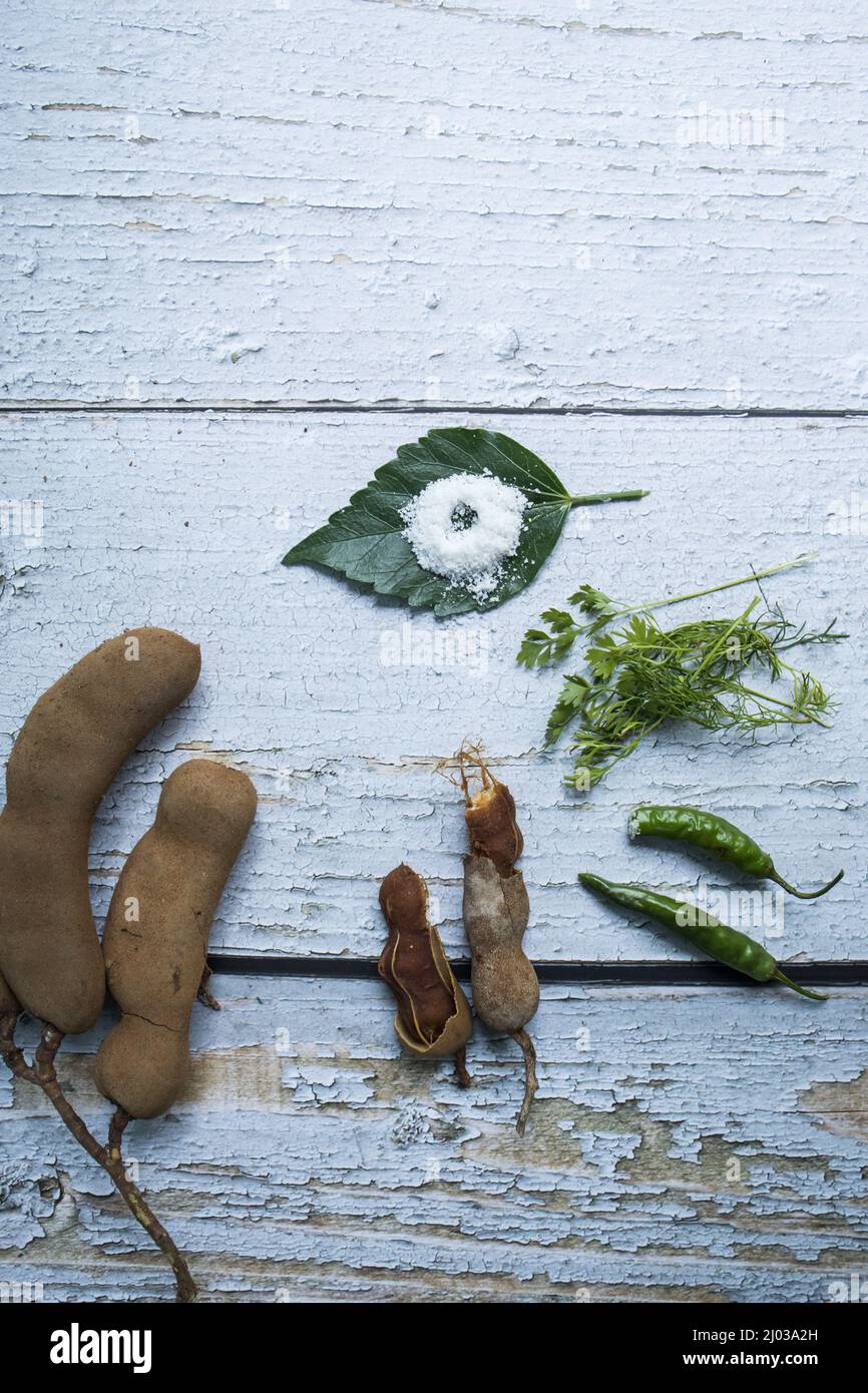Some raw tamarind with tamarind leaf Stock Photo - Alamy