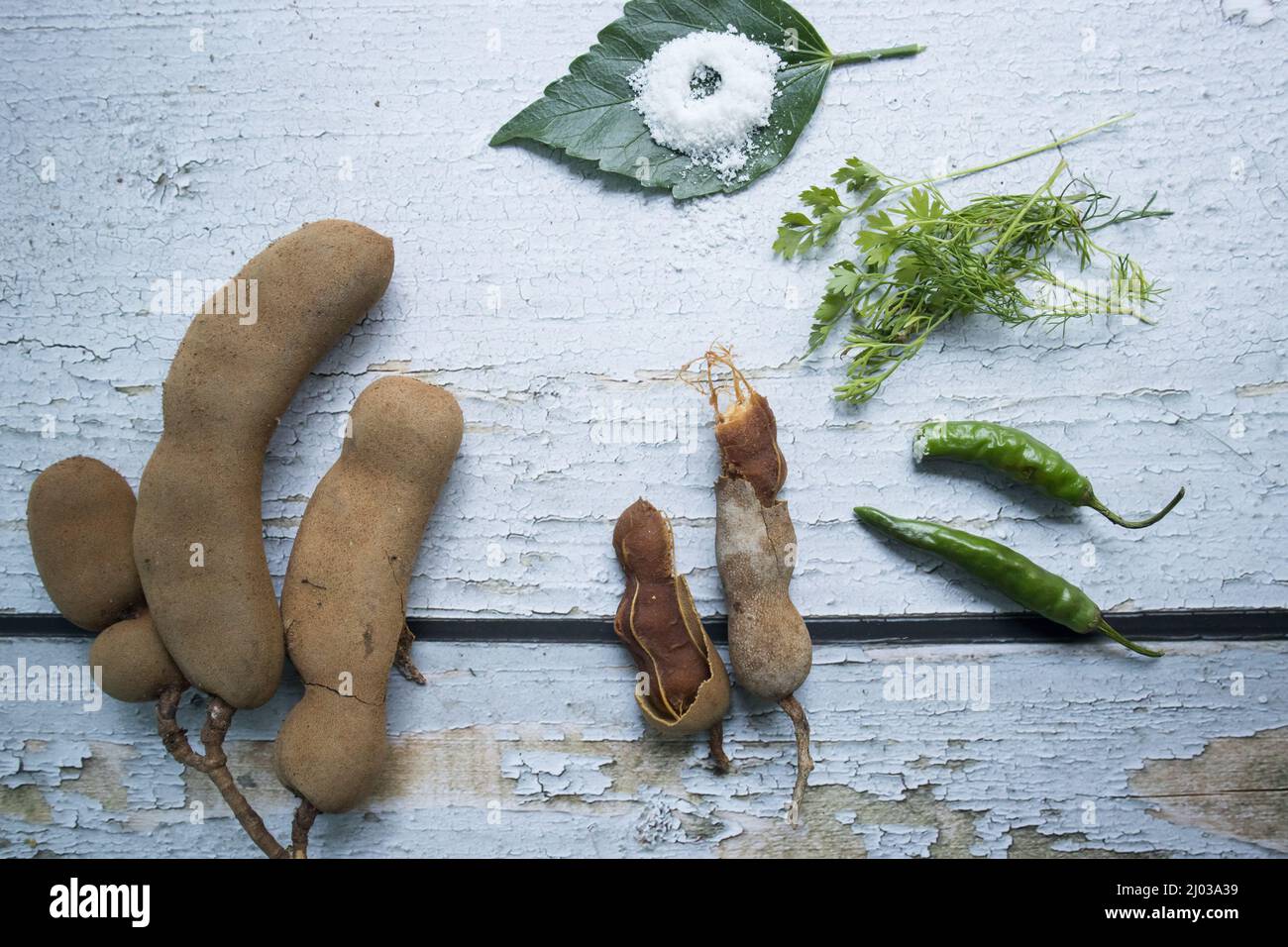 Some raw tamarind with tamarind leaf Stock Photo - Alamy