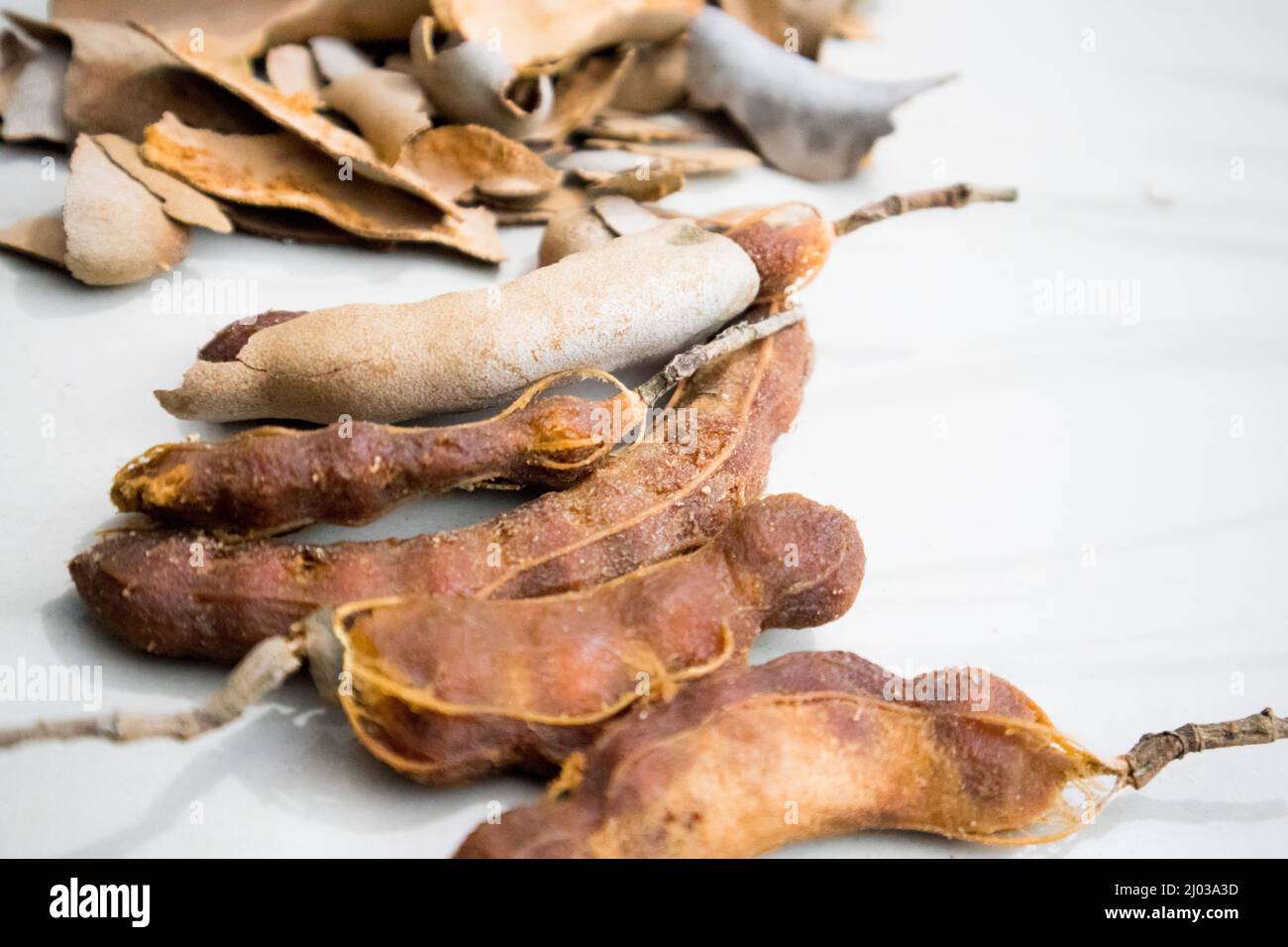 Some peeled tamarind with the shell in a white background Stock Photo ...