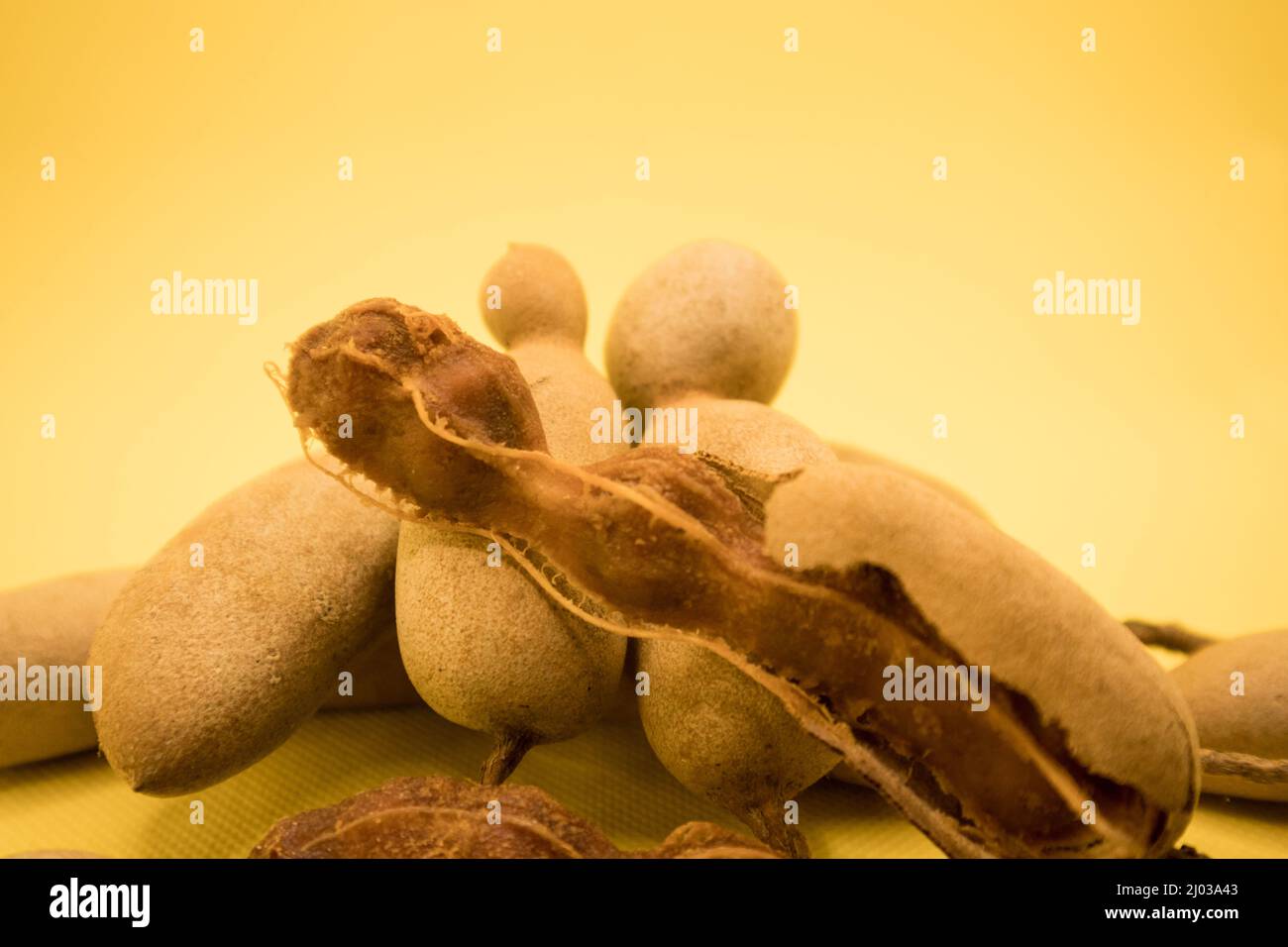 Tamarind in a yellow background Stock Photo - Alamy