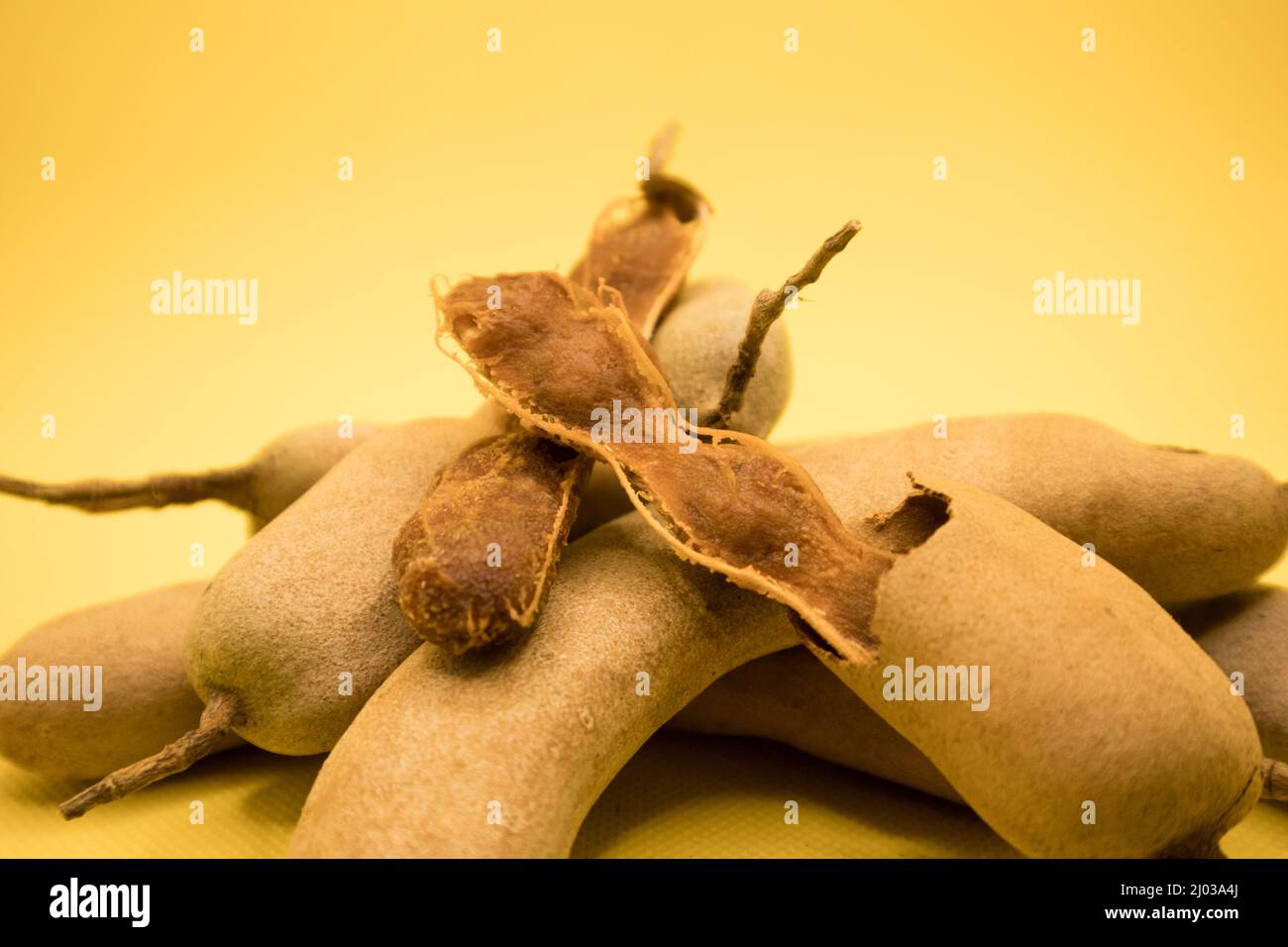 Tamarind in a yellow background Stock Photo - Alamy