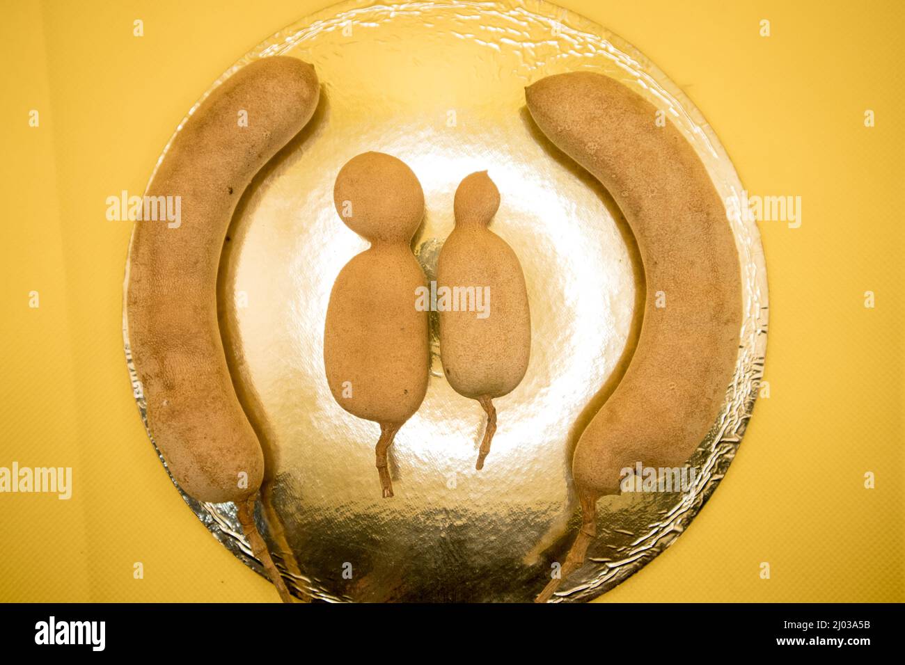 Four tamarind placed beautifully on golden background Stock Photo - Alamy