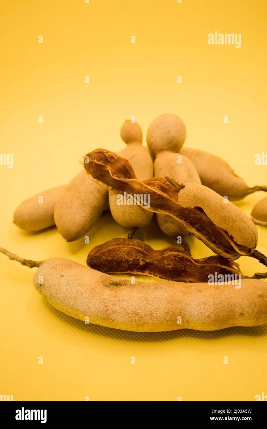 Tamarind in a yellow background Stock Photo - Alamy