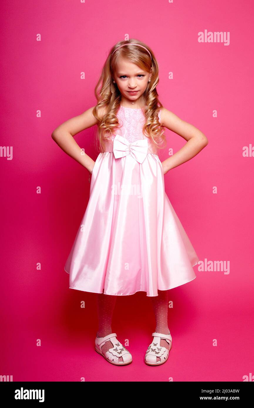 Pretty young kid girl in pink dress.Isolated studio shot Stock Photo ...