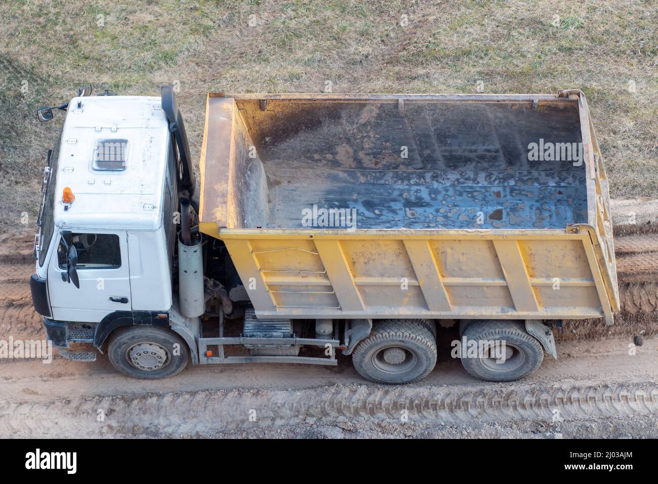 Construction works for laying pipes. Dump trucks involved in the ...