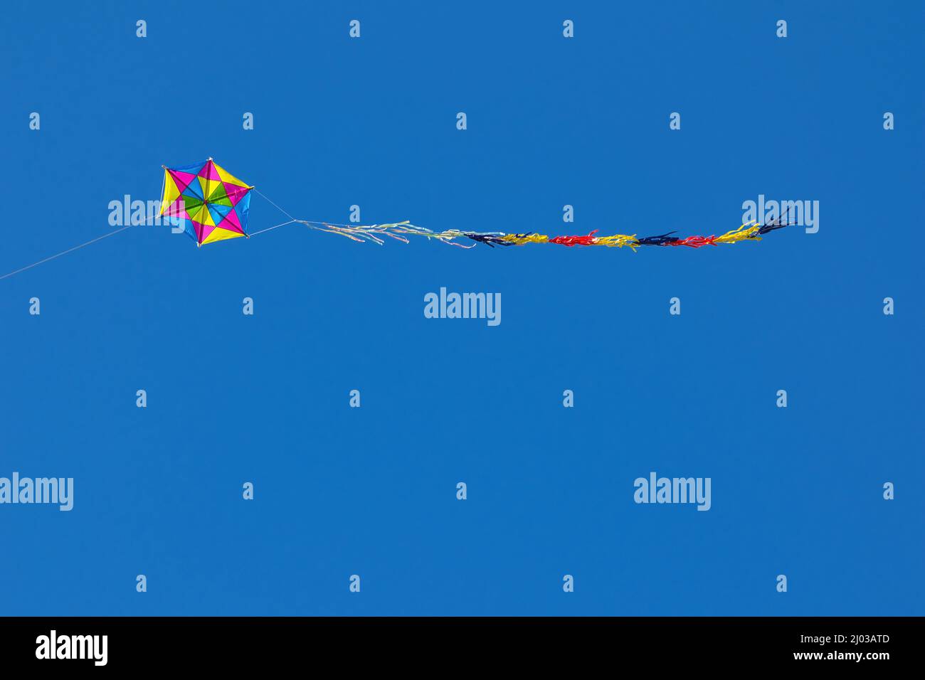 colorful kites in blue sky with small white clouds Stock Photo - Alamy