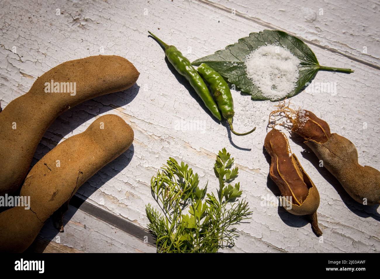 Some raw tamarind with tamarind leaf Stock Photo - Alamy