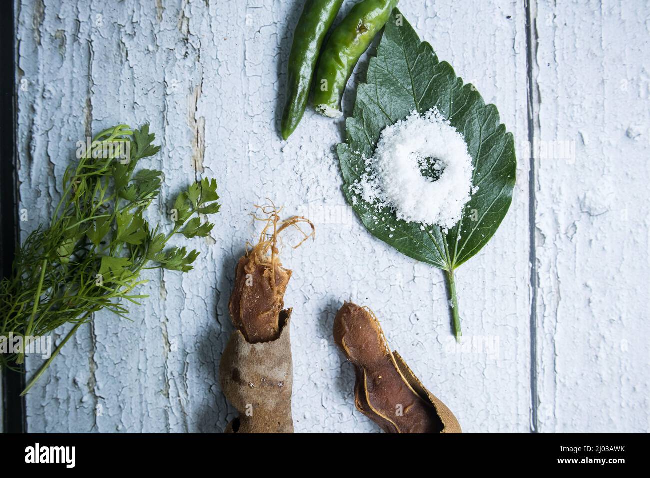 Some raw tamarind with tamarind leaf Stock Photo - Alamy