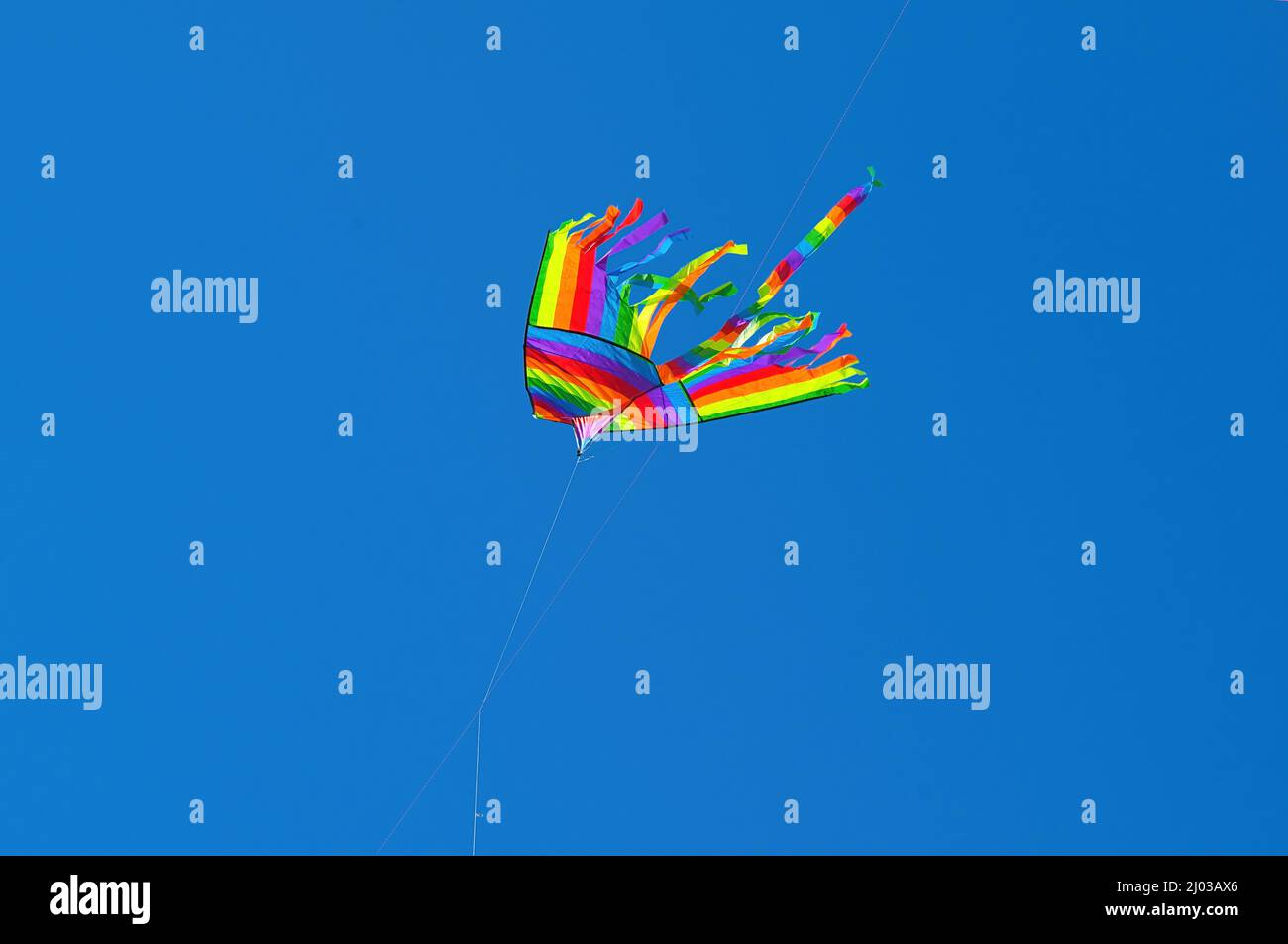 colorful kites in blue sky with small white clouds Stock Photo - Alamy