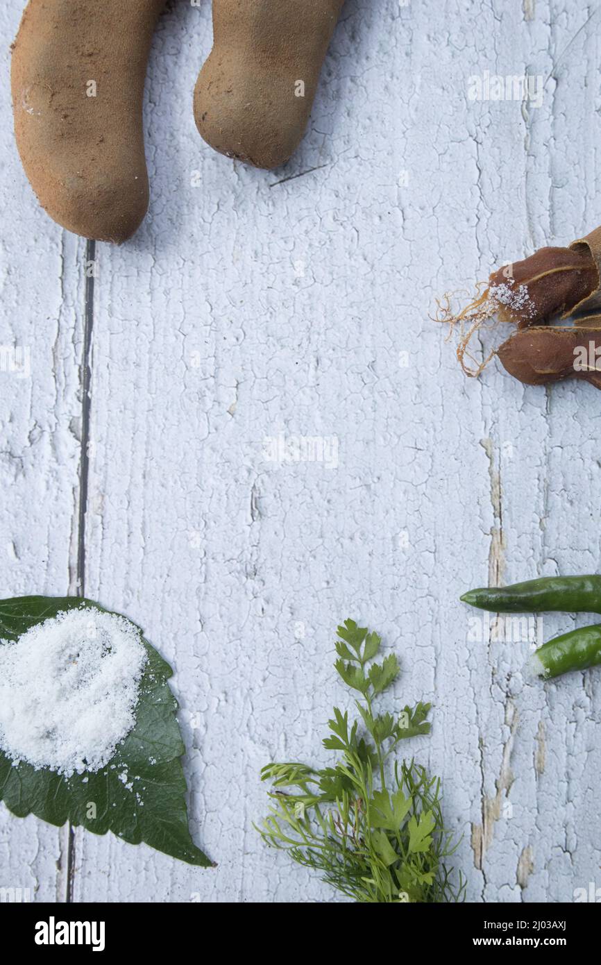 Some raw tamarind with tamarind leaf Stock Photo - Alamy