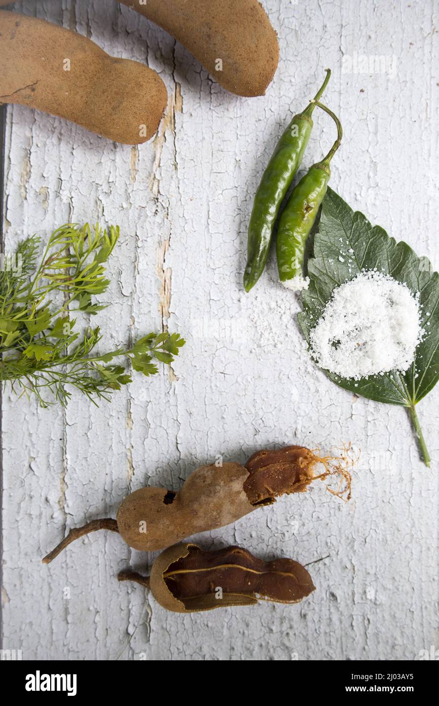 Some raw tamarind with tamarind leaf Stock Photo - Alamy