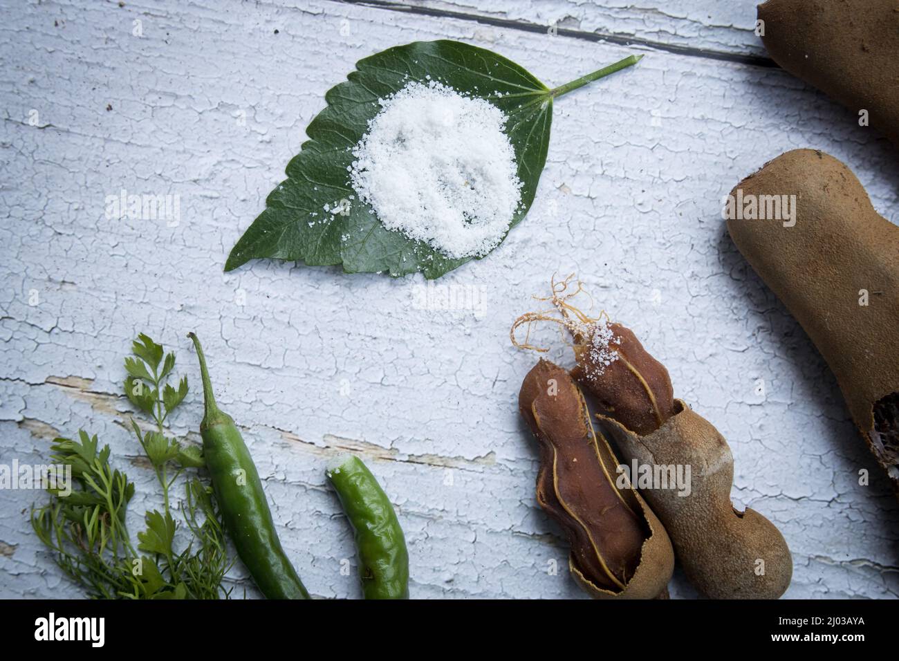 Some raw tamarind with tamarind leaf Stock Photo - Alamy