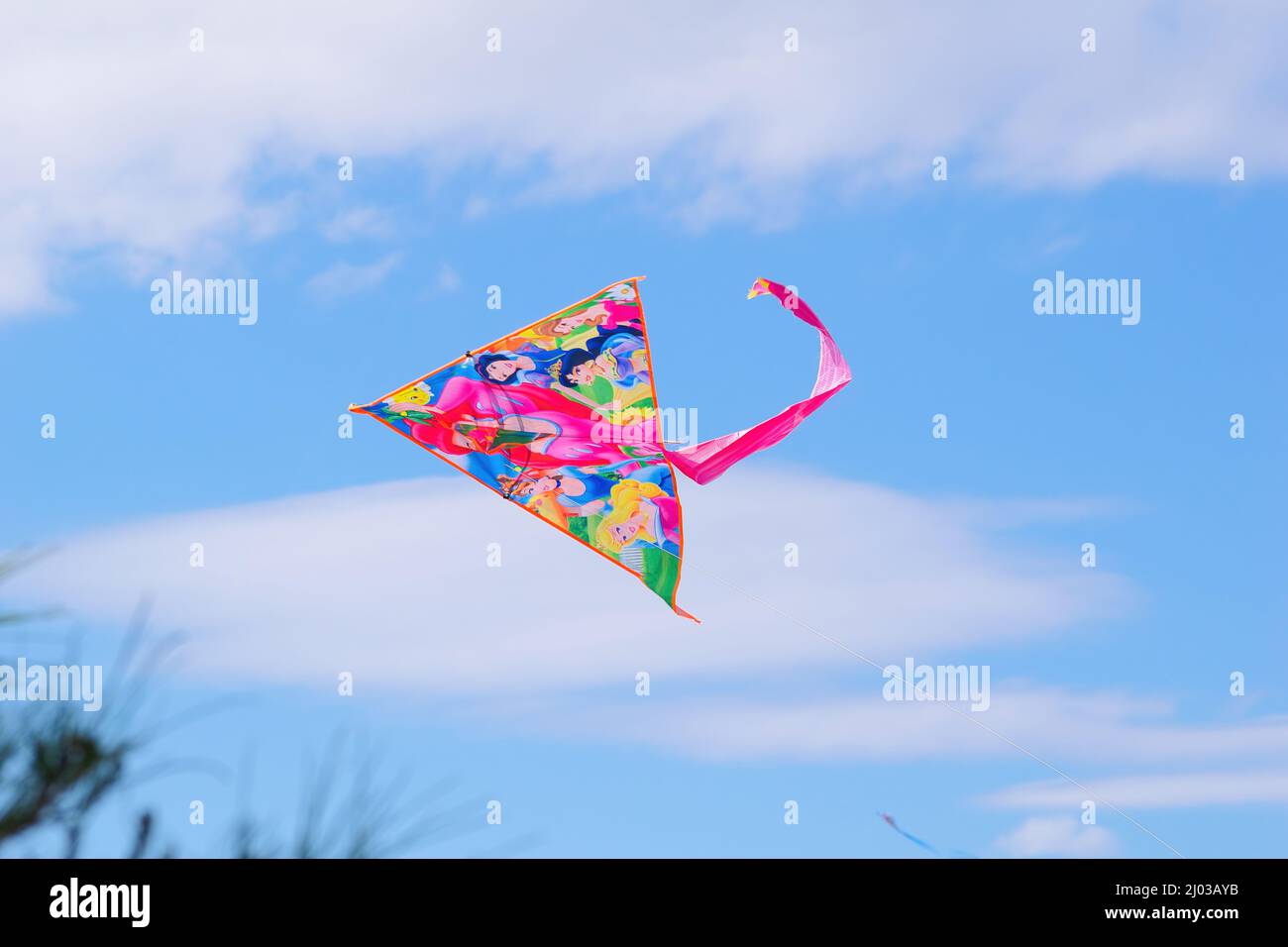 colorful kites in blue sky with small white clouds Stock Photo - Alamy